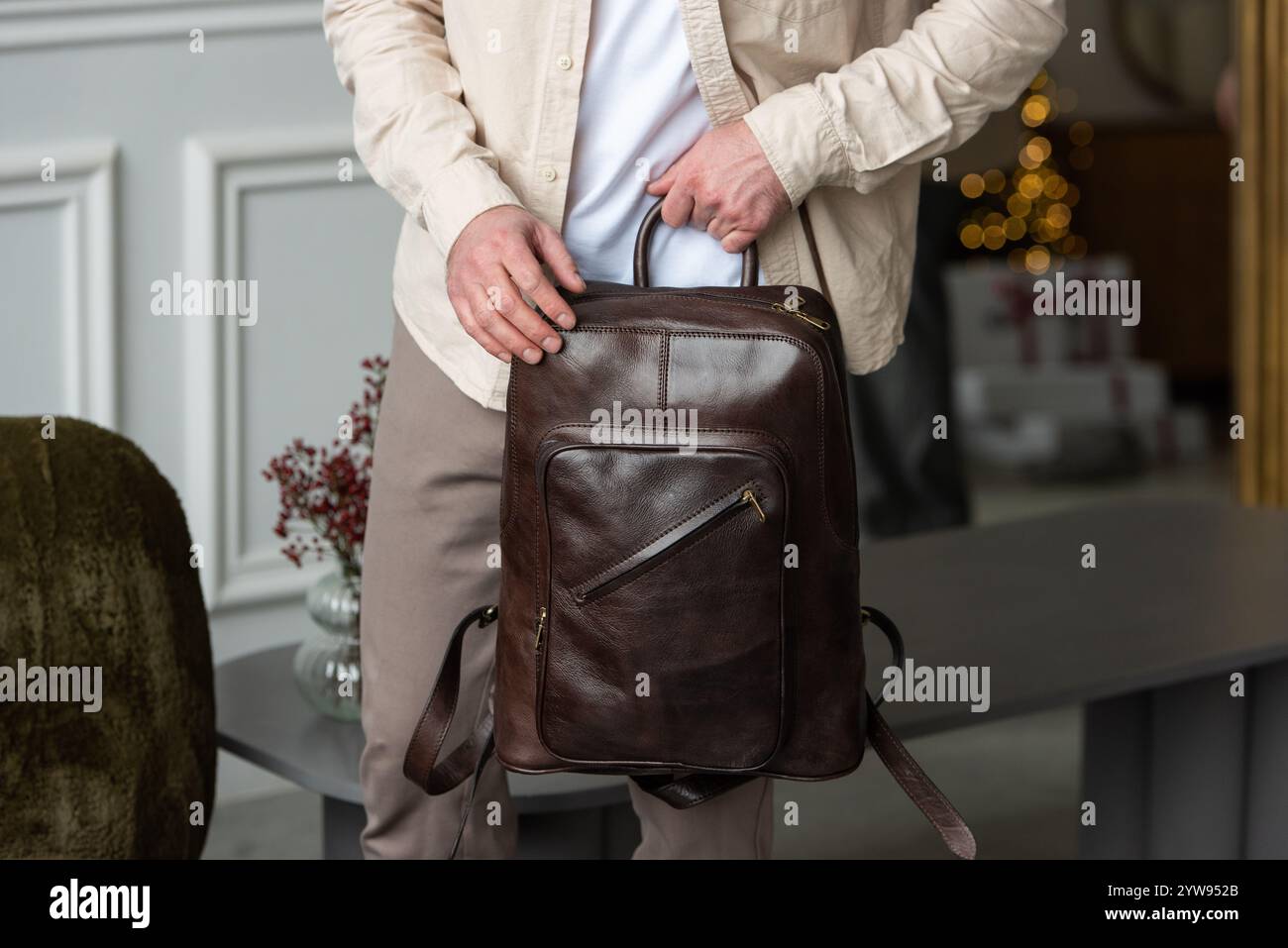 A Stylish and Professional Man Standing with a brown backpack in a ...