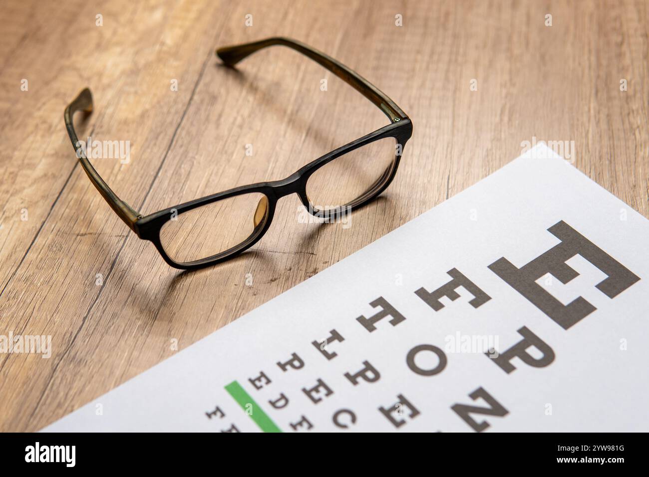 A pair of eyeglasses with an eye chart. Vision and eye care concept ...