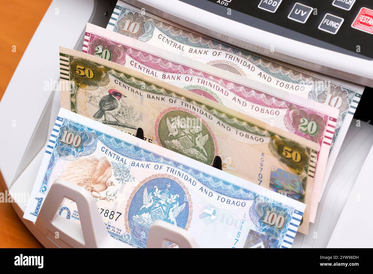 Trinidad and Tobago money - dollar in the counting machine Stock Photo ...