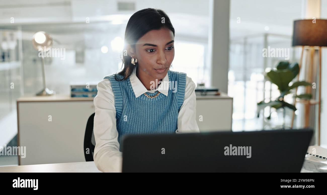 Accounting, laptop and reading with business Indian woman at desk in ...