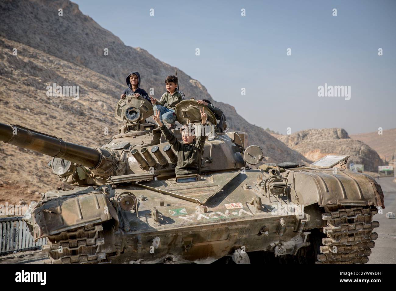 Children play on a tank in Syria close to the border with Lebanon ...