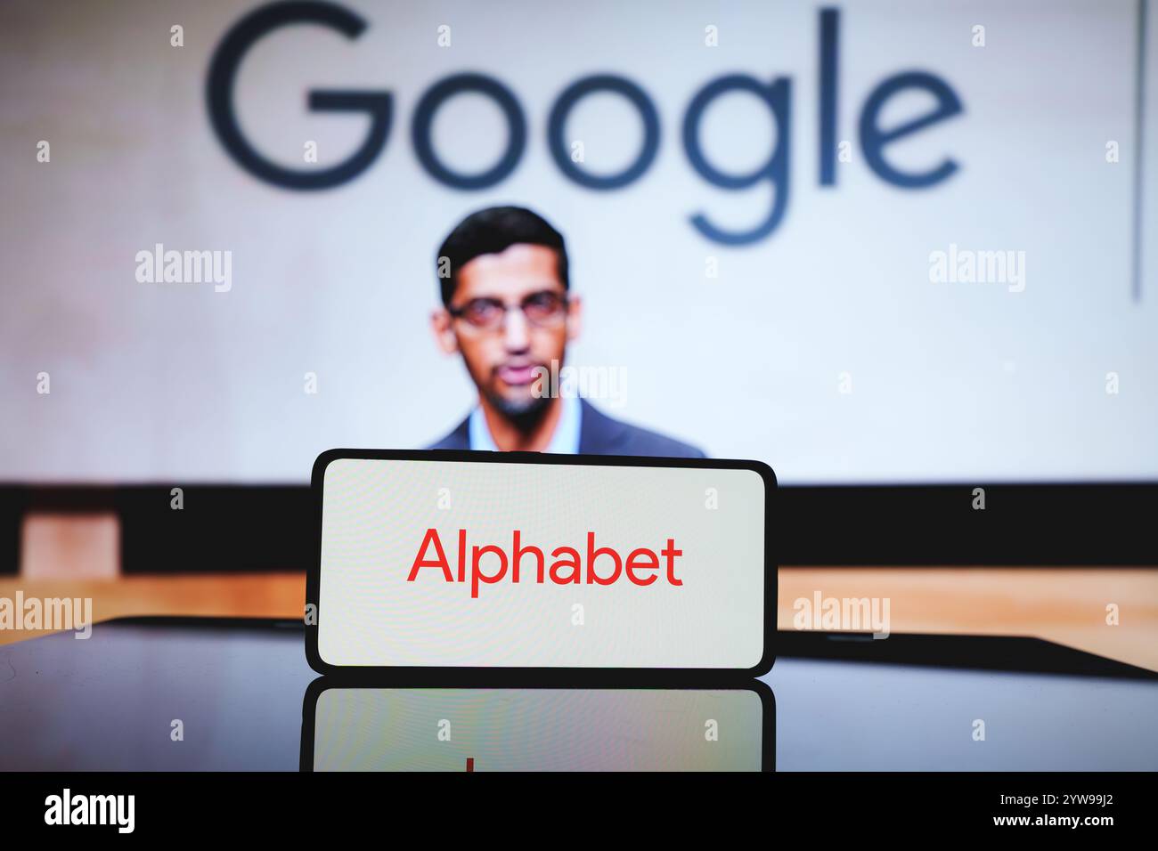 Google Alphabet logo and company CEO Sundar Pichai on background ...
