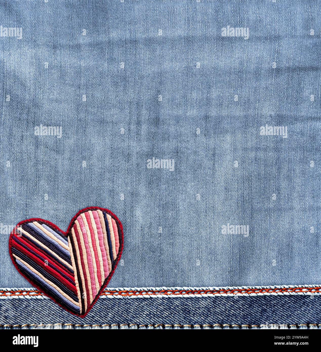 Light blue denim background with a seam and felt heart. Suqare blue ...