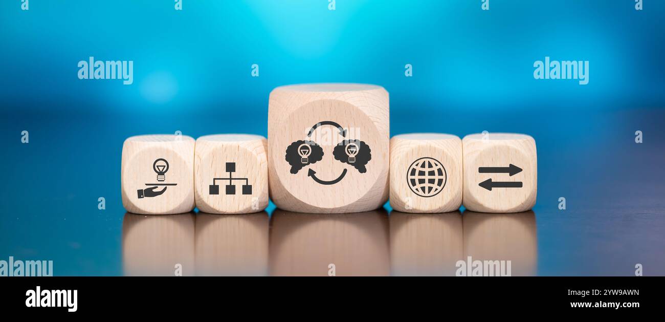 Wooden blocks with symbol of knowledge sharing concept on blue ...