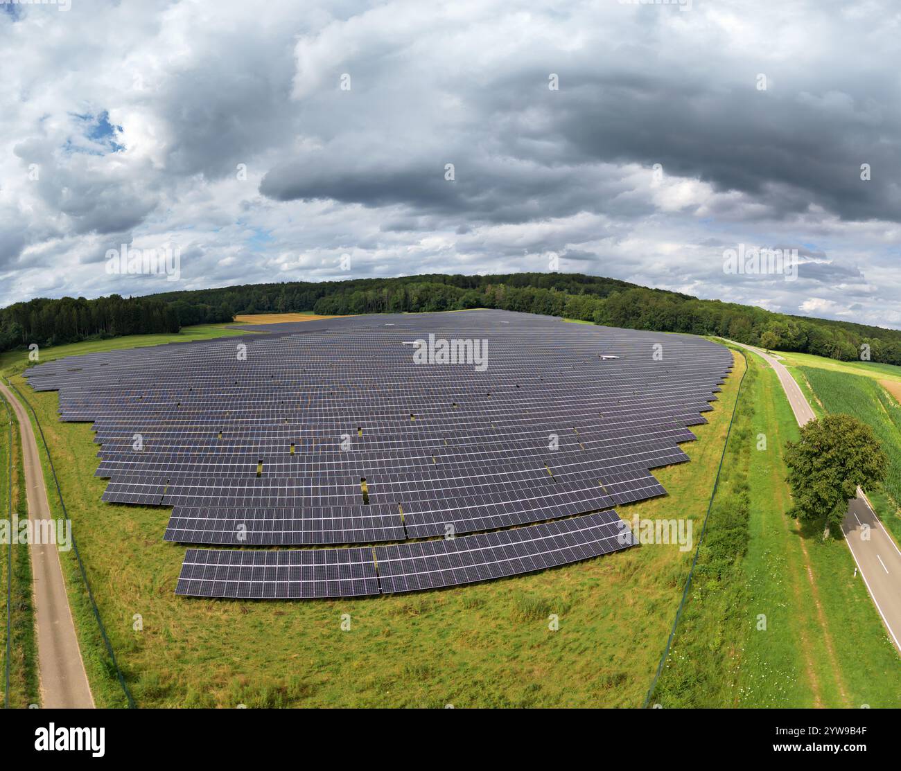 Larger solar field with solar cells under cloudy skies in late summer ...