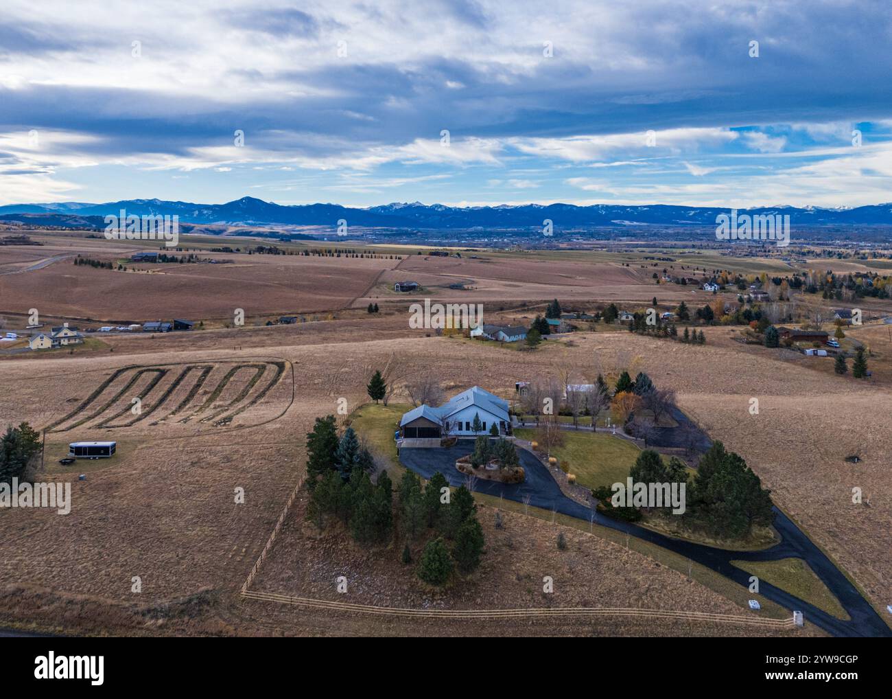 The beautiful Montana landscape, open grassland, fences, dirt road, and ...