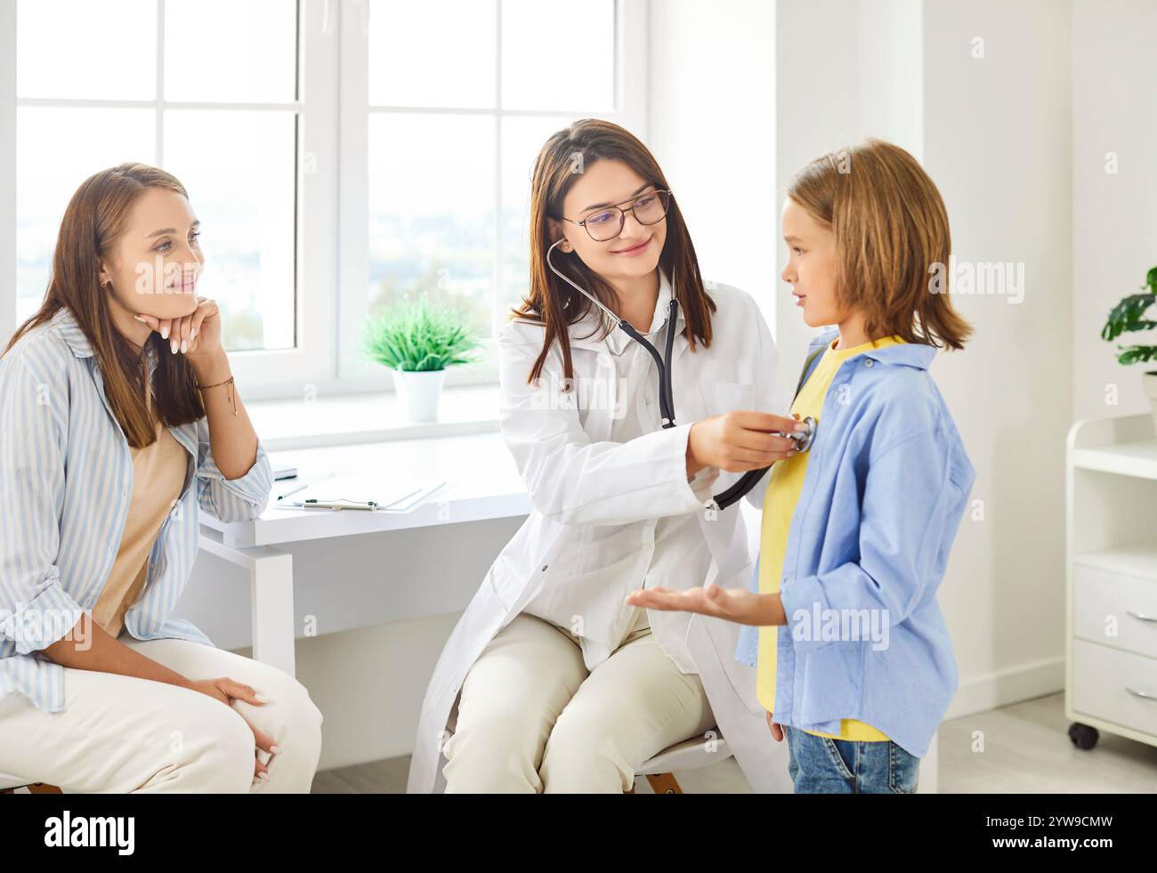 Little child girl visiting a doctor with her mother in clinic for a ...