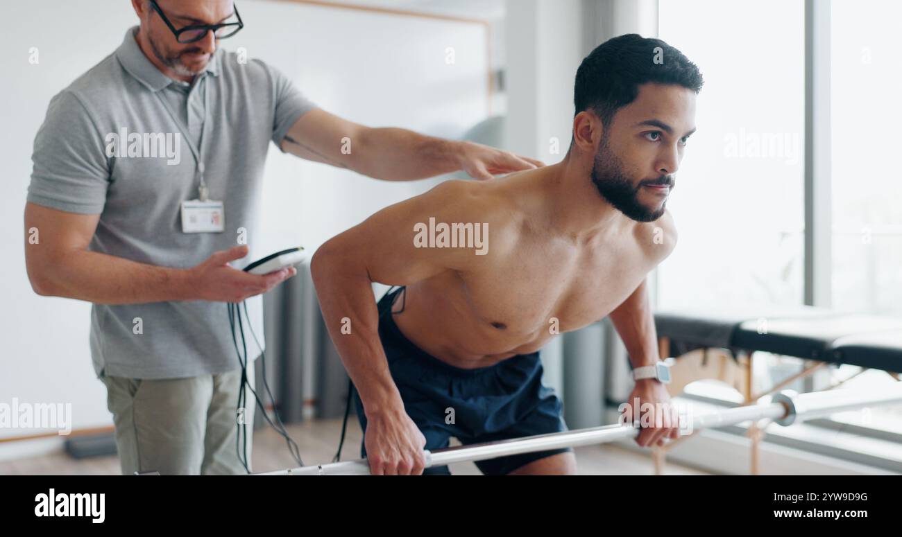 Physiotherapy, consulting and monitor with man in clinic for biofeedback, muscle stimulation and ...