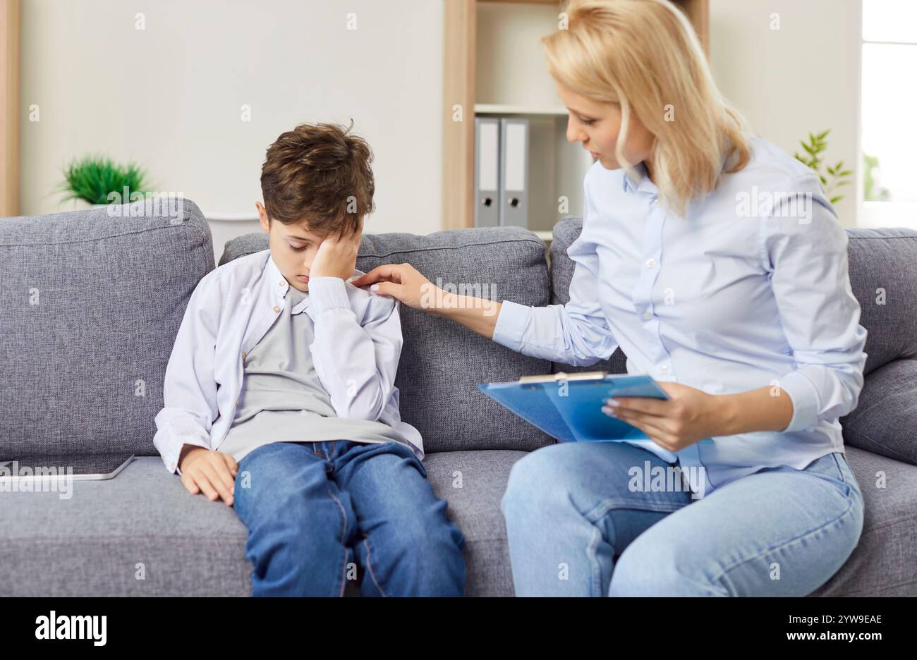 Doctor Psychologist Comforting A Sad And Crying Boy During Therapy ...