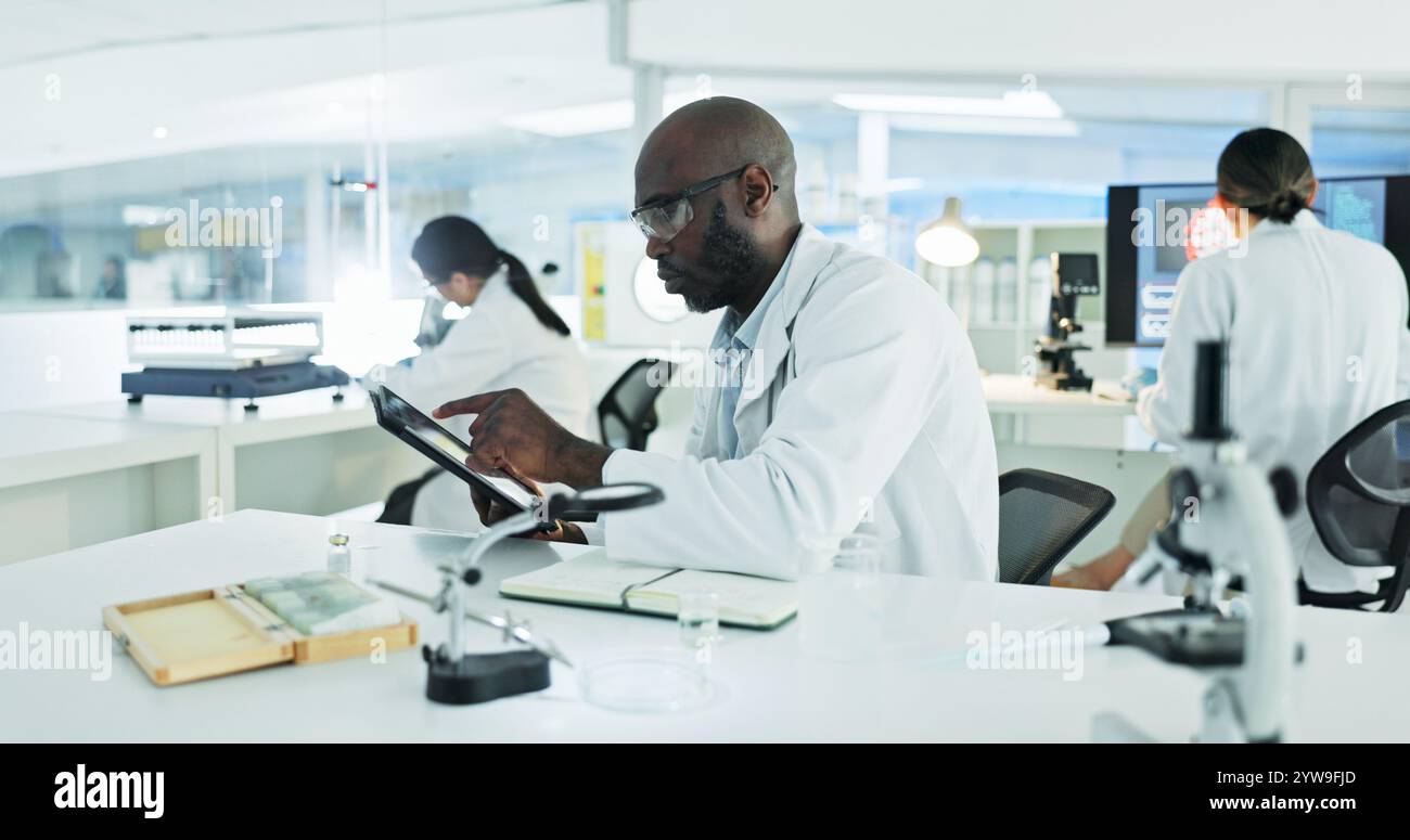 Black man, scientist ad tablet at laboratory for research on medical or ...