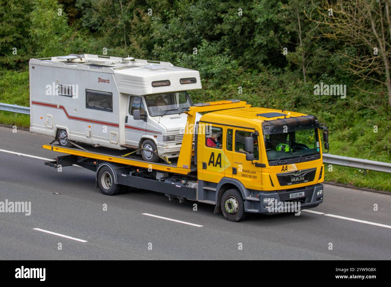 AA MAN recovery truck carrying broken Monarch Caravan; Side view of ...