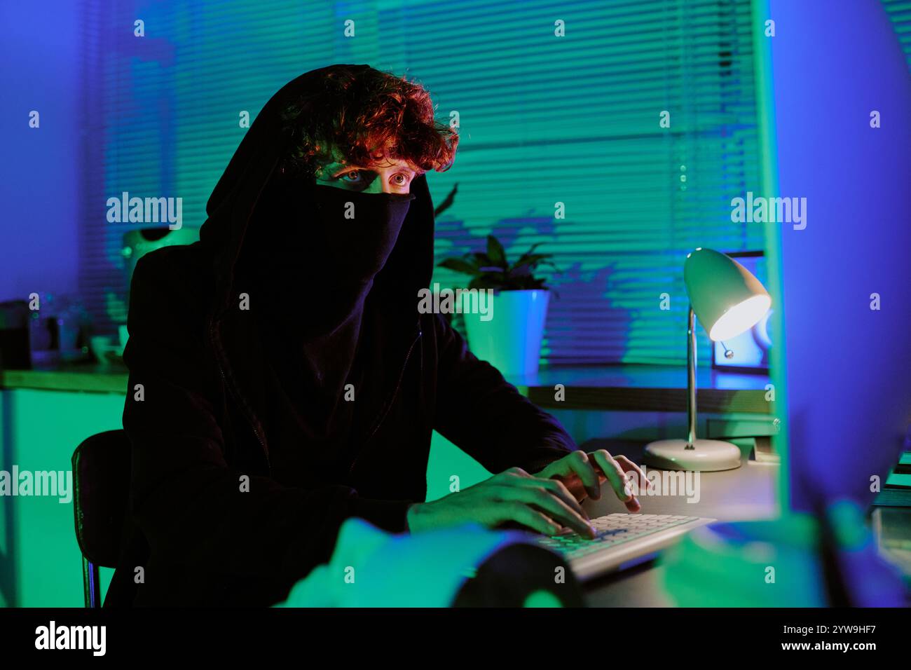 Medium close up ref curly haired man wearing black mask to hide his ...
