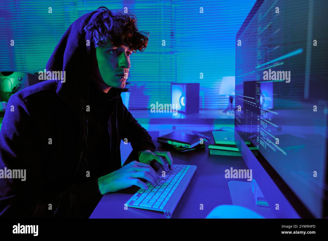 Medium close up of young adult man typing on keyboards while coding, he ...
