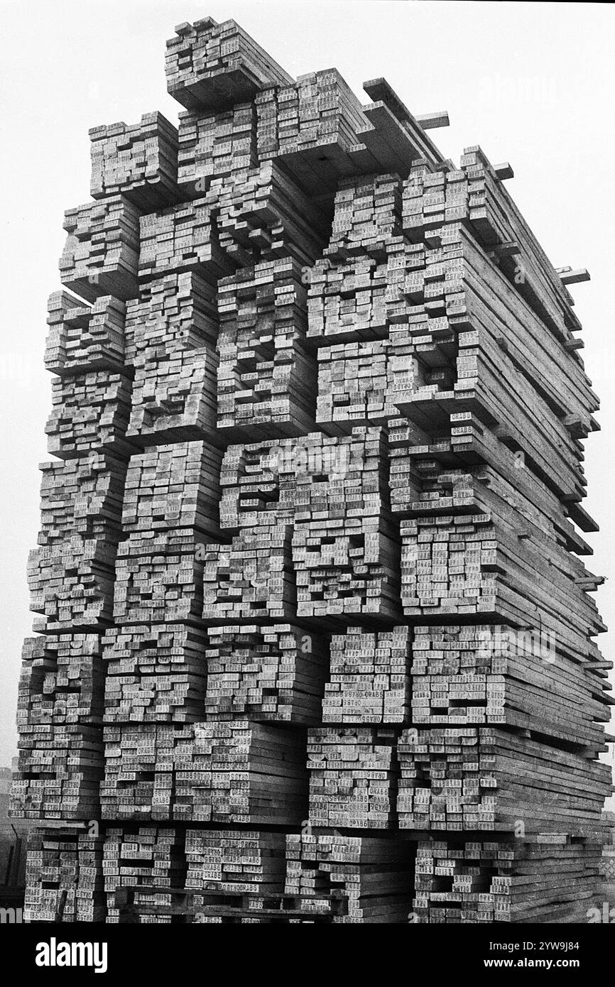Timber stacked at docks awaiting transportation, 1930's Stock Photo - Alamy