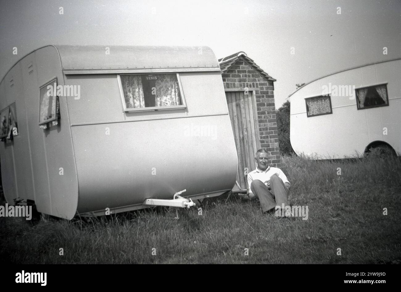 1950s, historical, a mature man sitting on the grass for his photo by ...