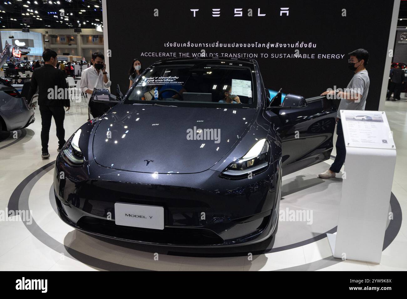 In this photo illustration, visitors inspect a Tesla Model Y car during ...