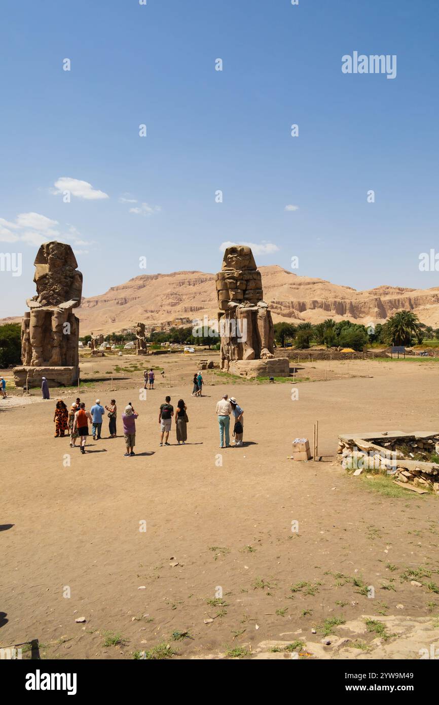 Tourists at The giant Colossi of Memnon. All that remains of the Temple ...