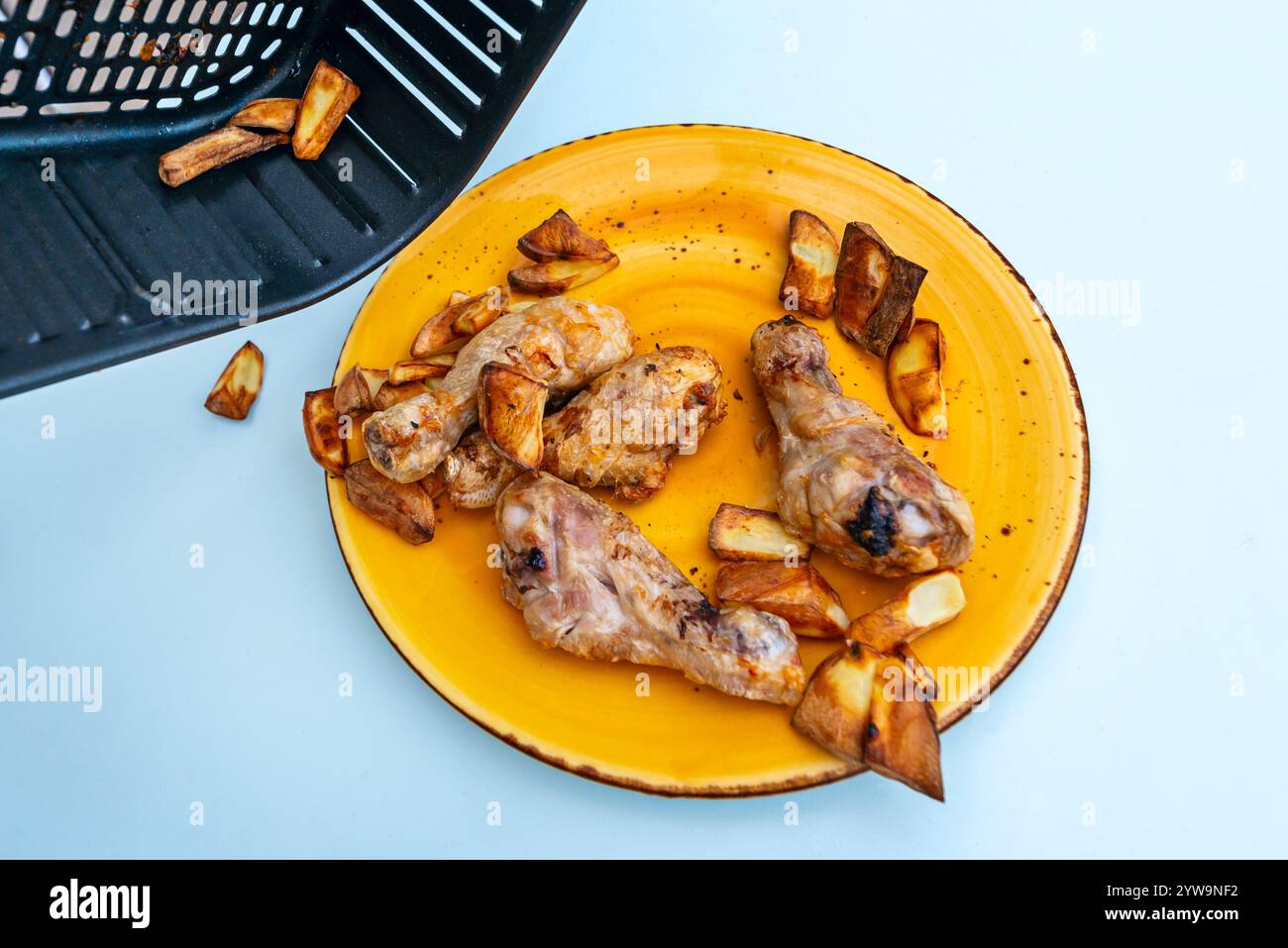 How to flip cooked chicken thighs and potatoes on a plate in an air ...