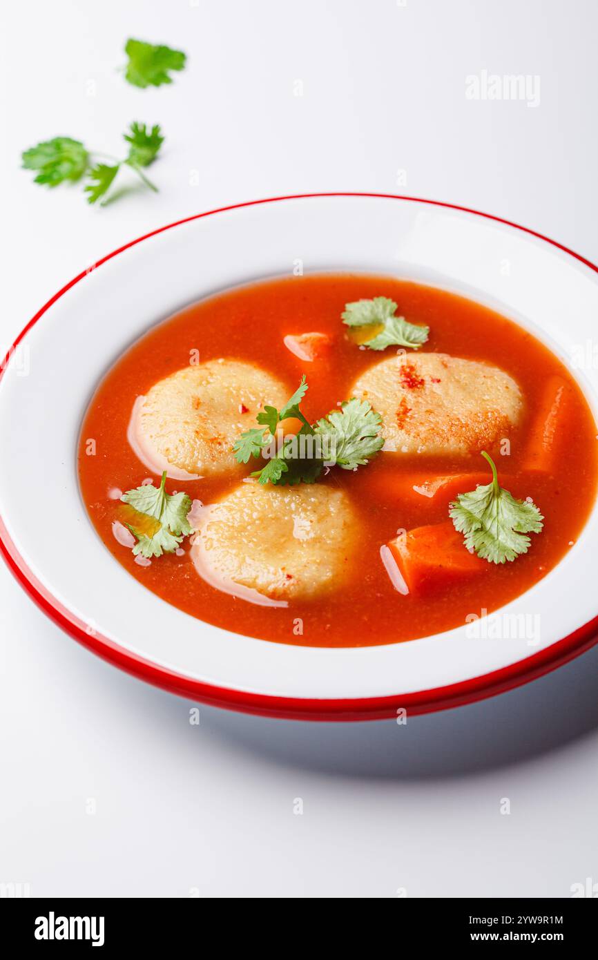 Traditional Jewish tomato soup with matza meatballs, white background ...