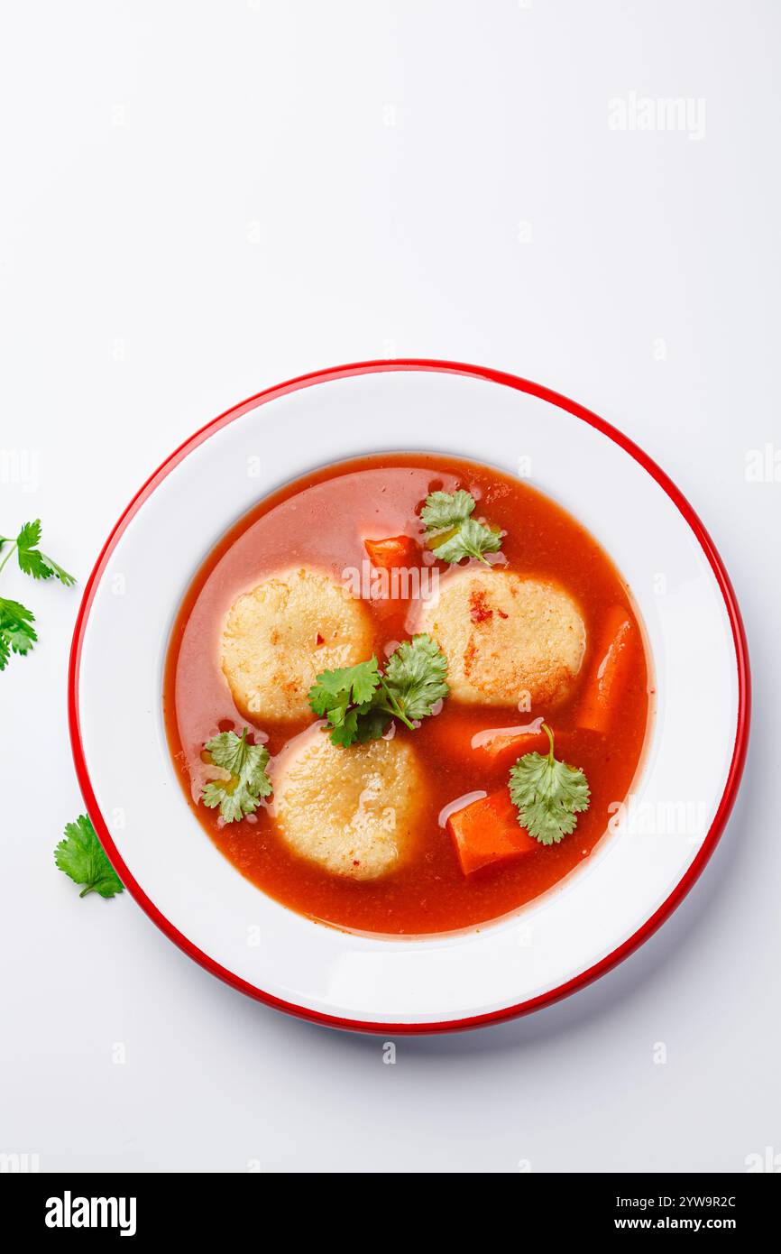 Traditional Jewish tomato soup with matza meatballs, white background ...
