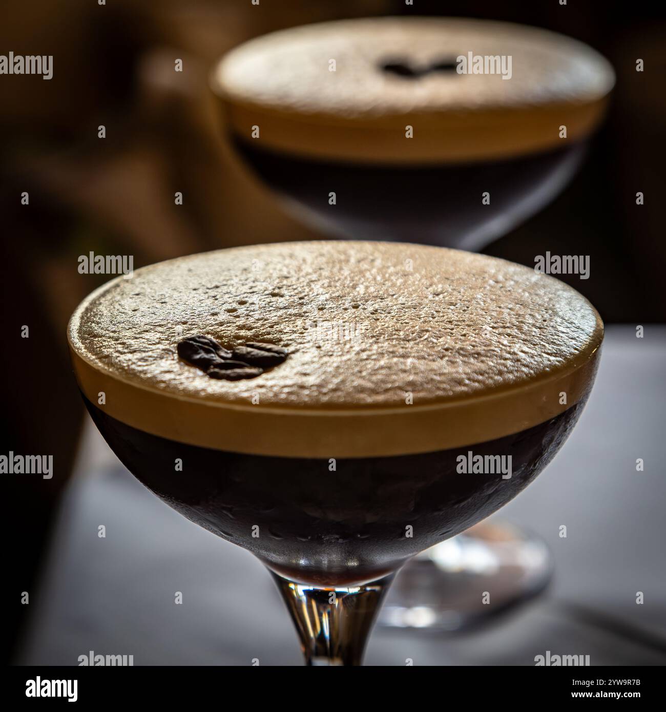 Two espresso martini cocktails in an atmospheric bar Stock Photo - Alamy