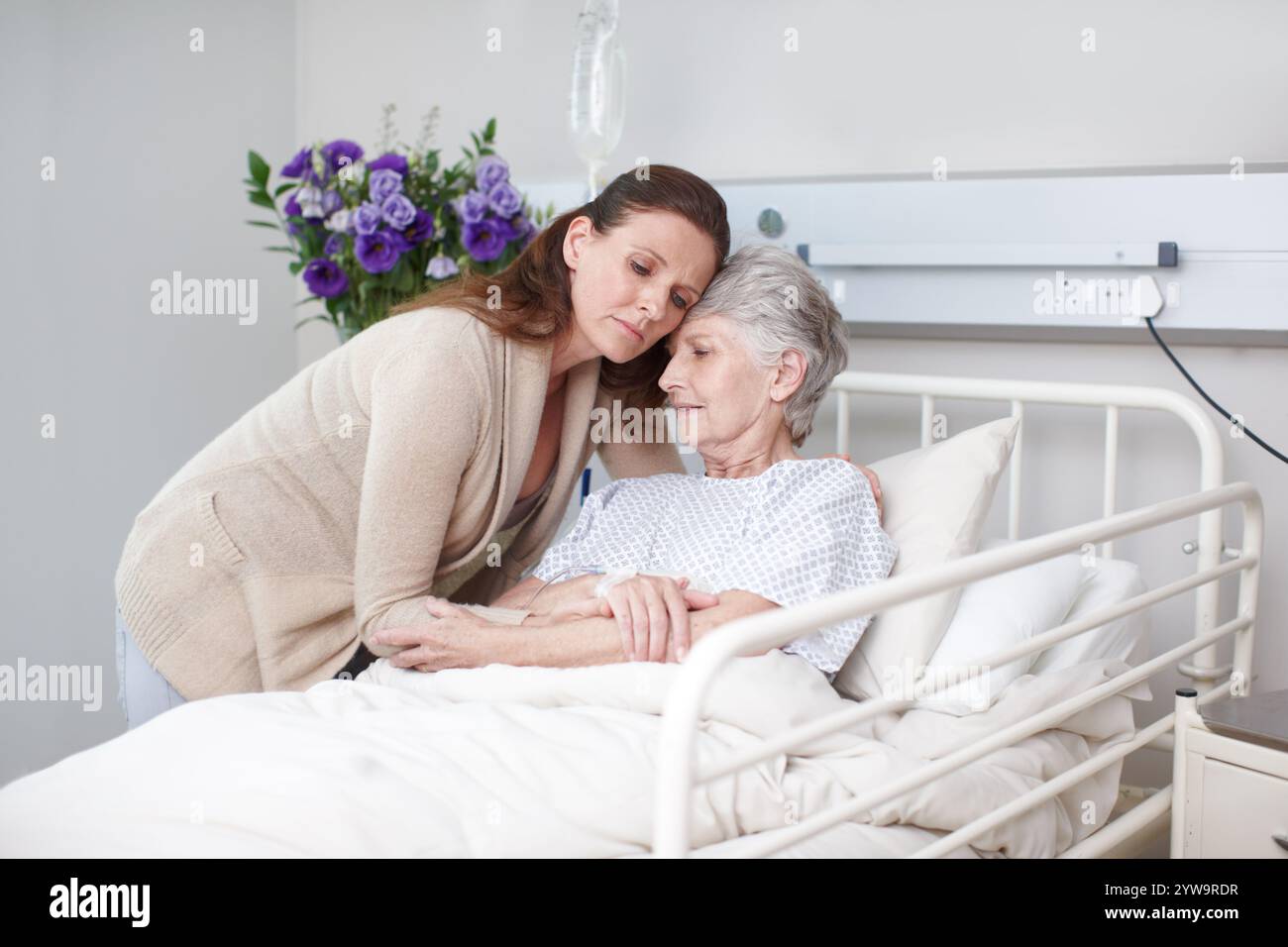 Elderly woman, daughter and hug in hospital for medical exam ...