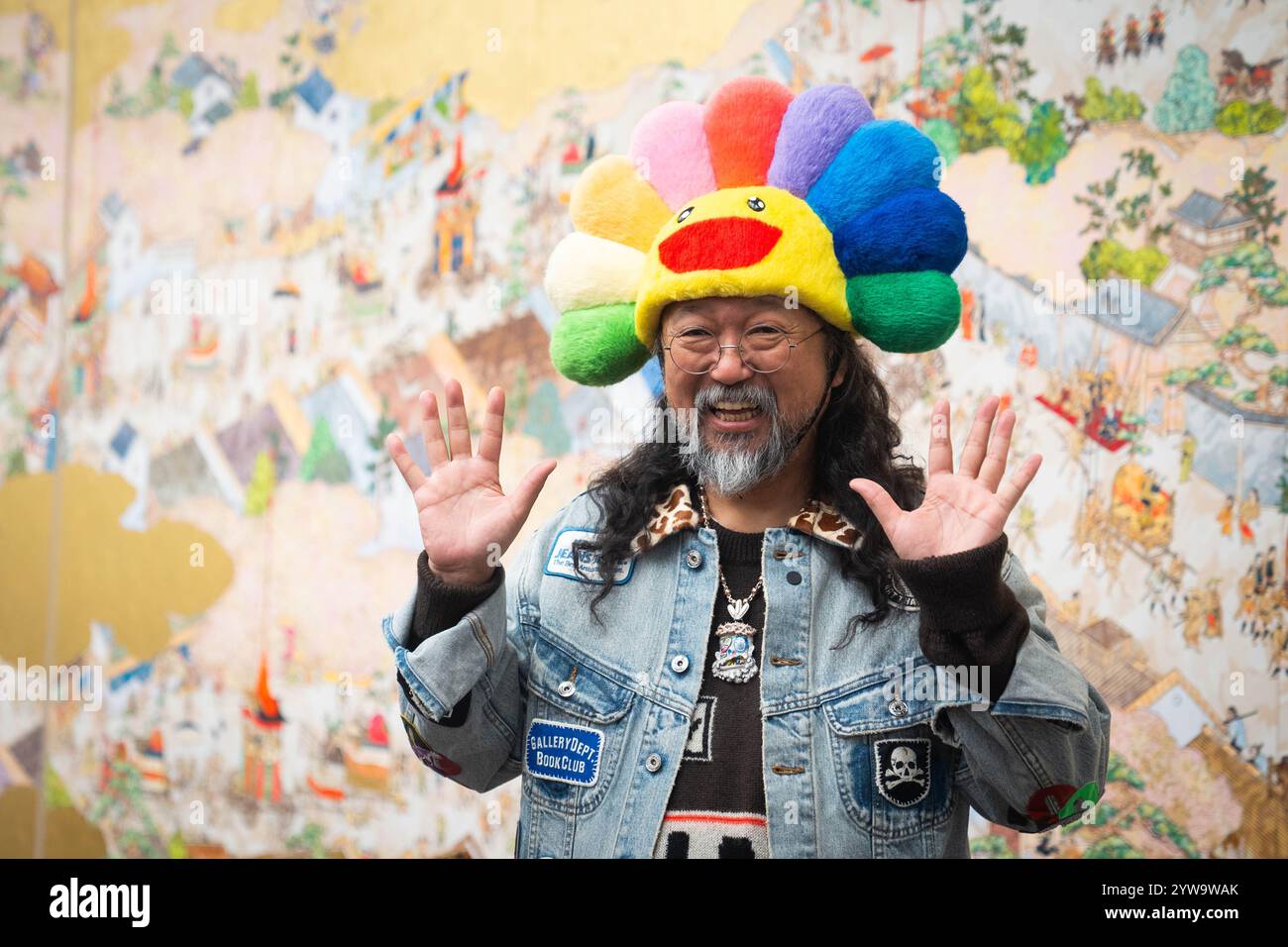 Artist Takashi Murakami poses in front his work named Gion Sairei-zu ...