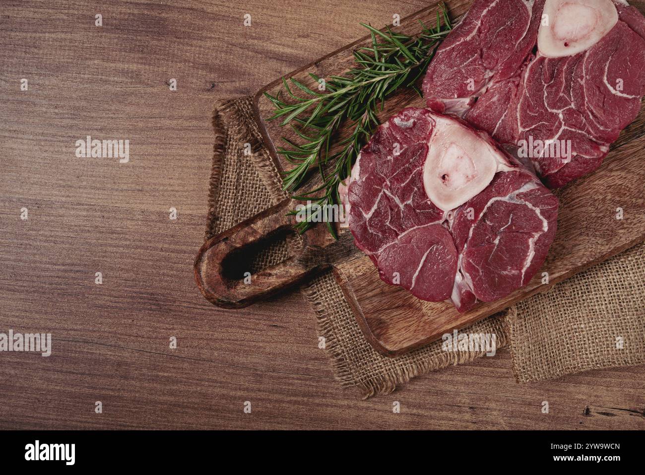 Knuckle on the bone, raw meat for ossobuco, on a wooden chopping board ...