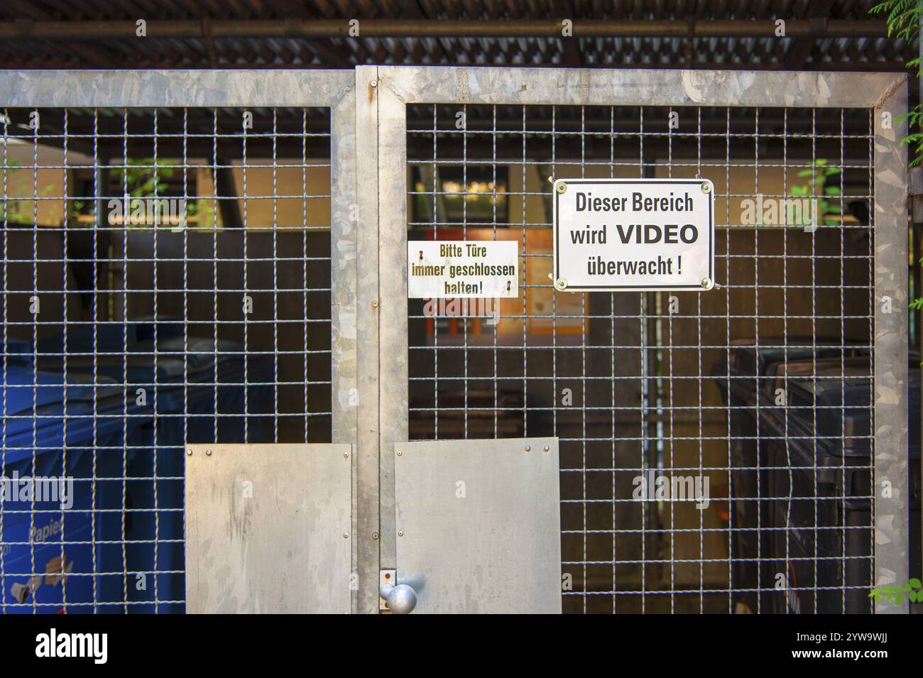 Barred door with security notice, video surveillance, keep door closed ...