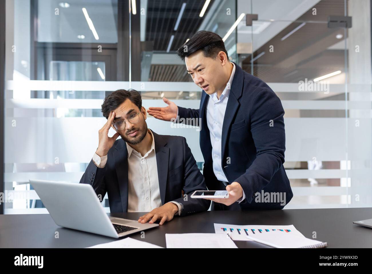 A frustrated employee is scolded by his boss during a tense office ...