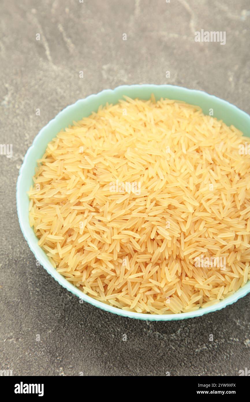 Rice grains on mint plate on grey concrete background. Top view Stock ...