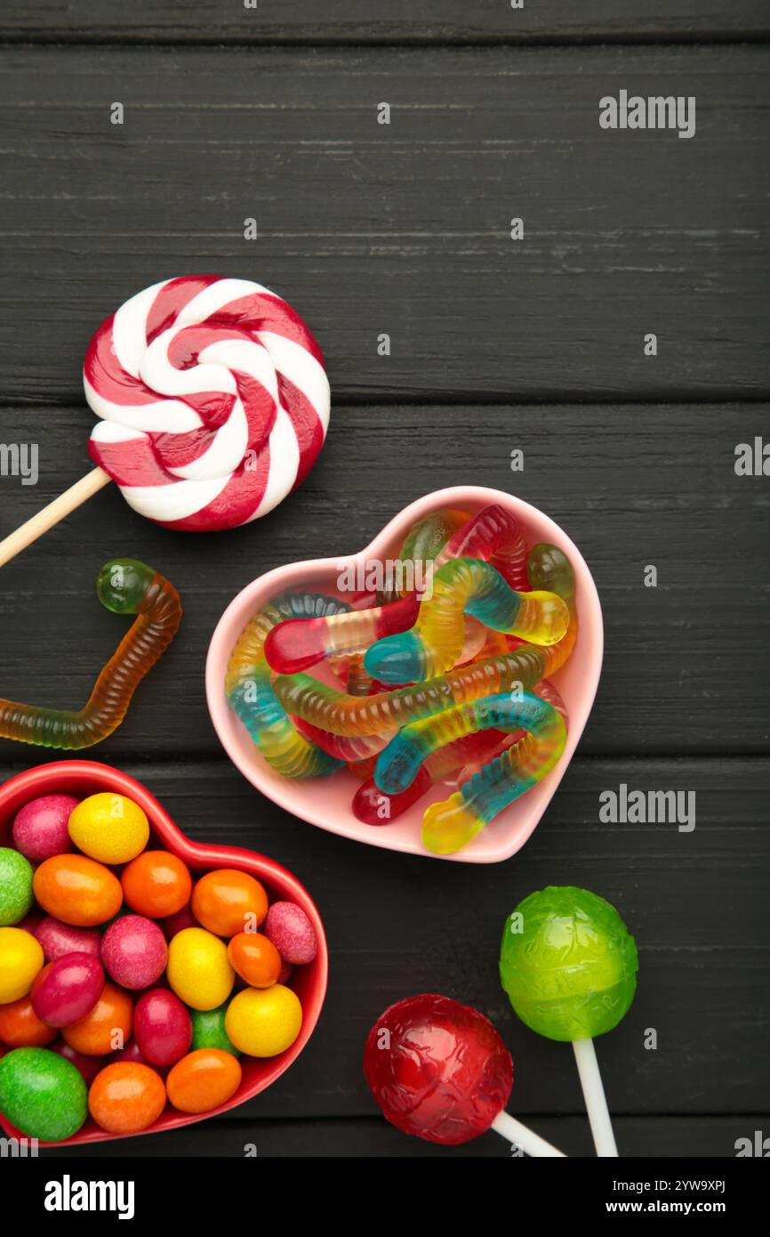 Different types of candies on black wooden background, copy space ...