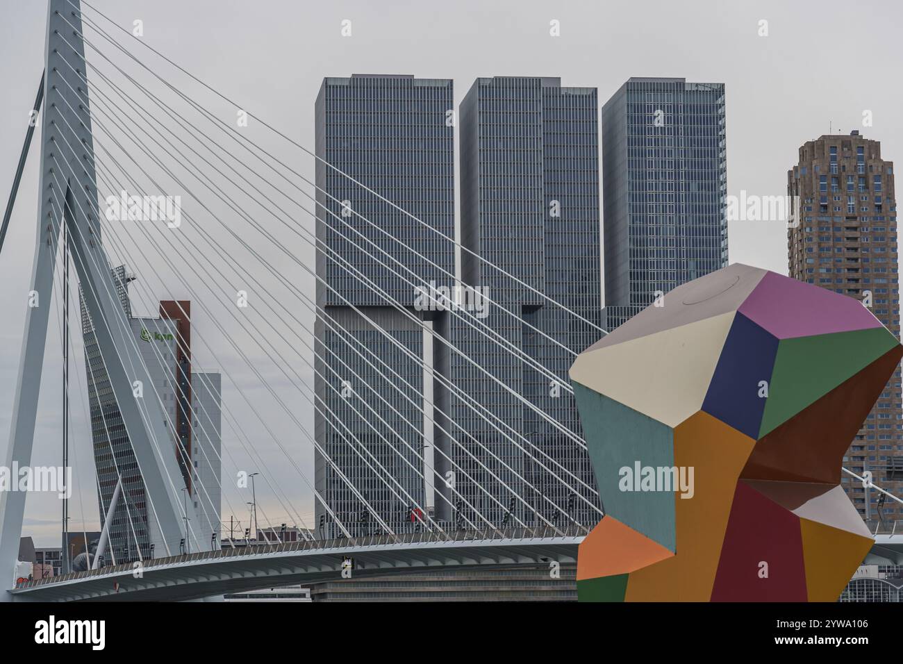 Colourful artwork next to a striking urban bridge and skyscrapers ...