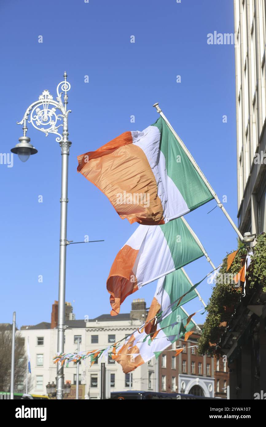 Irish tricolour flags blowing in the breeze outside a pub in a main ...