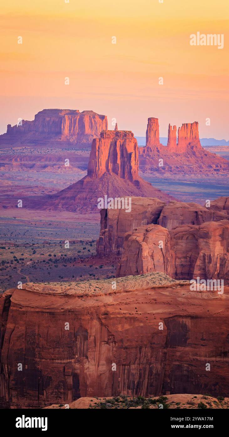 Golden sunrise paints the towering sandstone buttes and mesas of Hunts ...