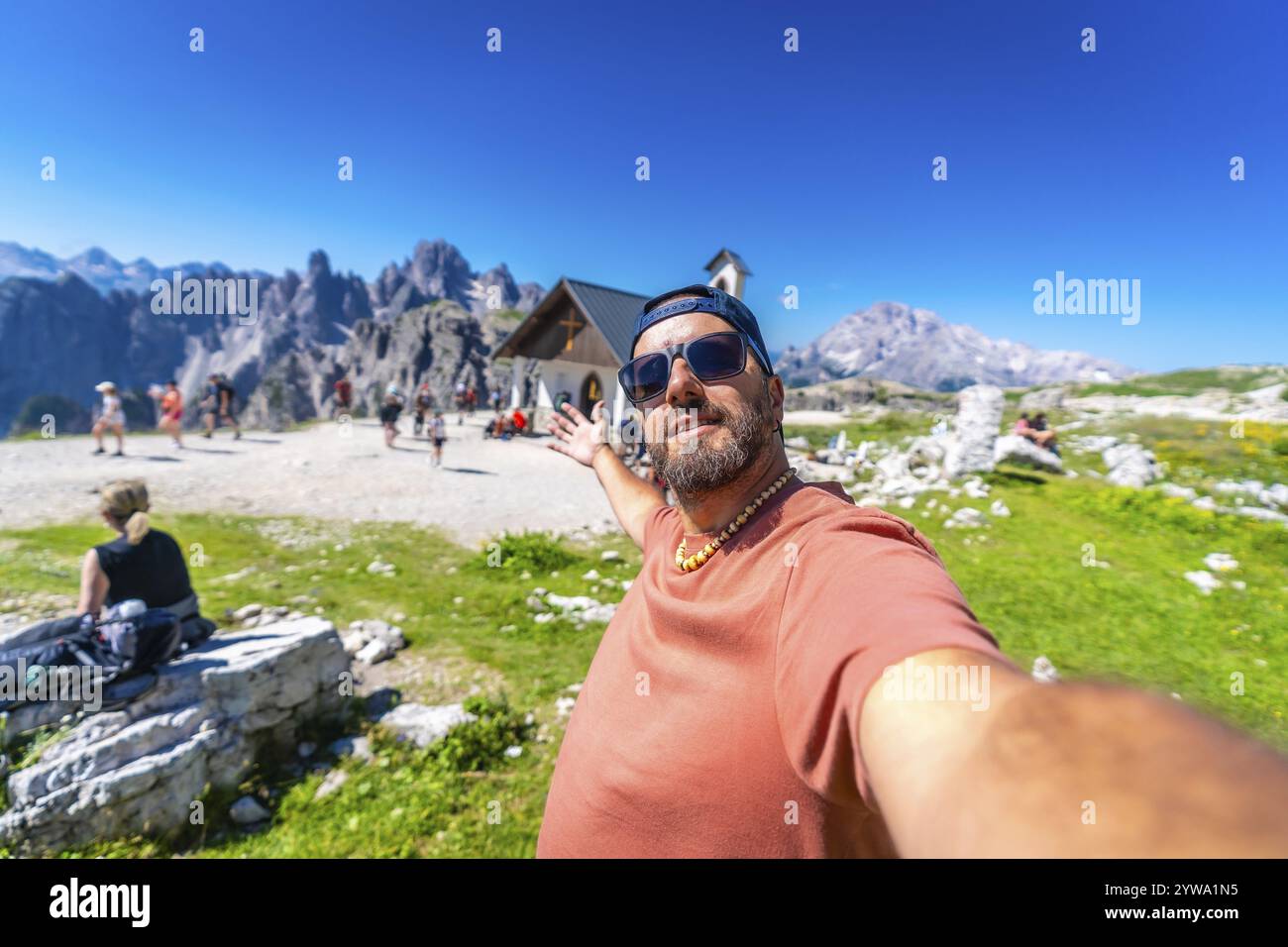 Tourist taking a selfie with open arms in front of the chapel on the ...