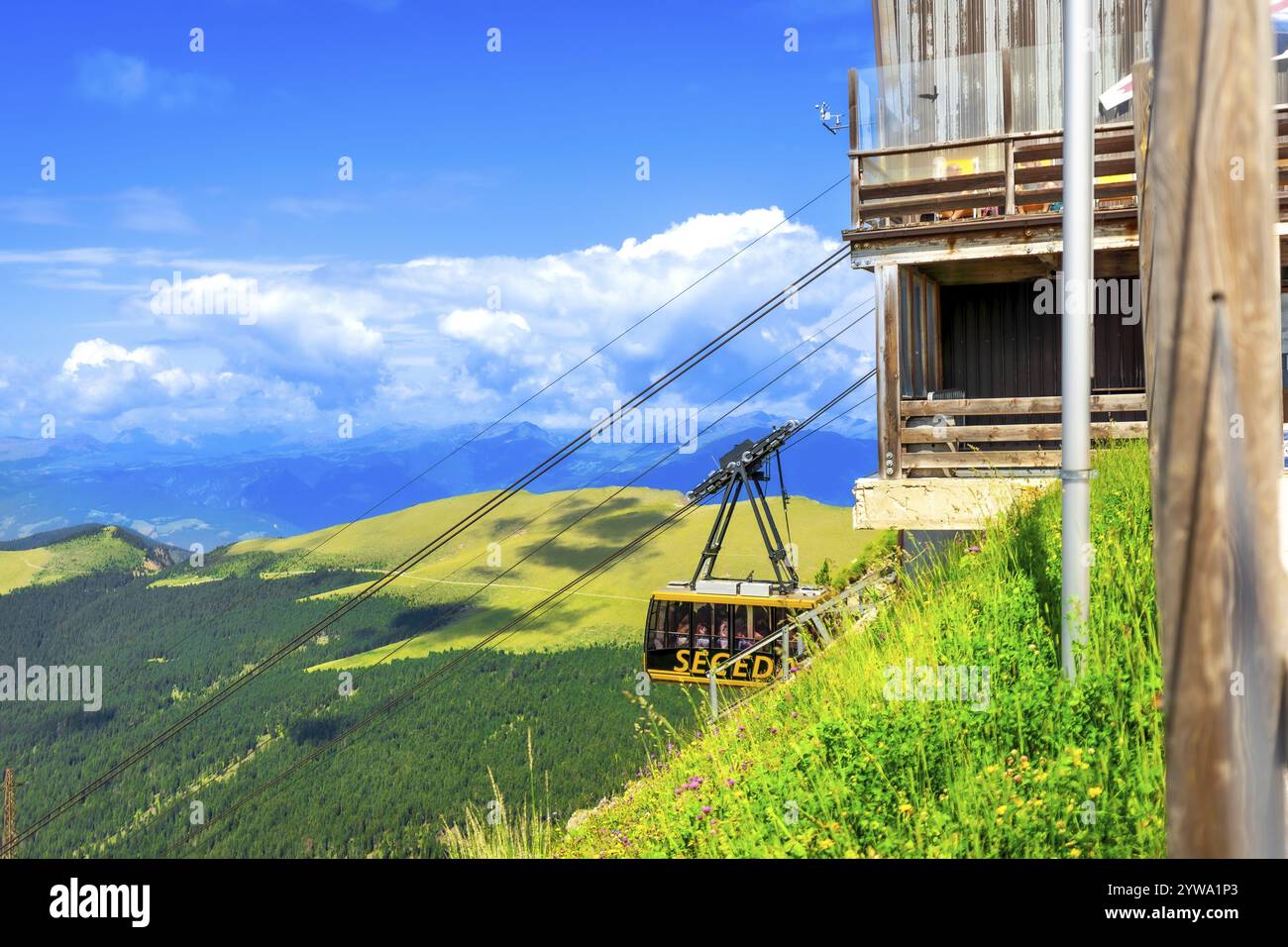 Cable car transporting tourists up seceda mountain with stunning views ...