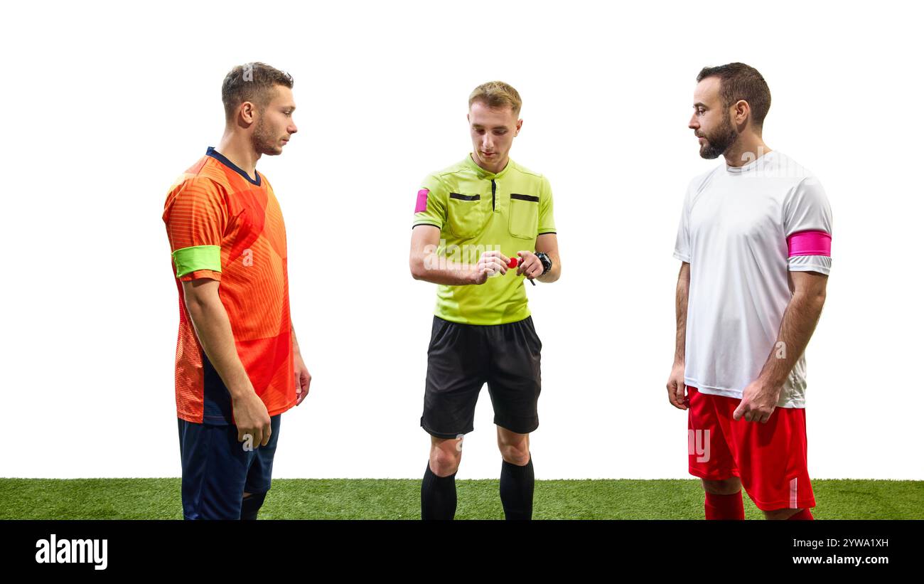 Referee standing between to players from opposite teams and tossing a ...
