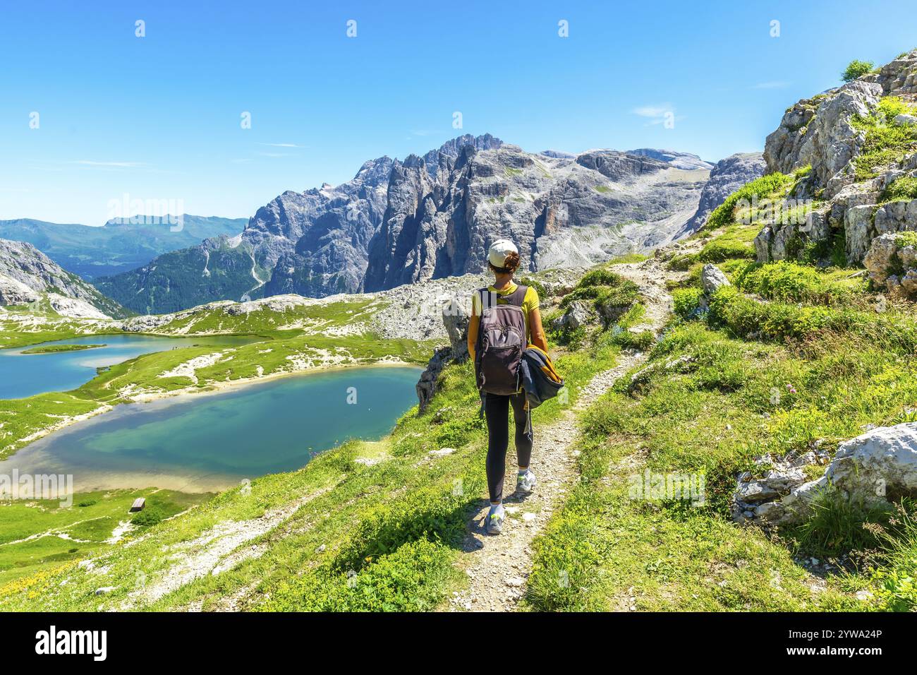 Tourist enjoying the scenic view of the tre cime di lavaredo and alpine ...
