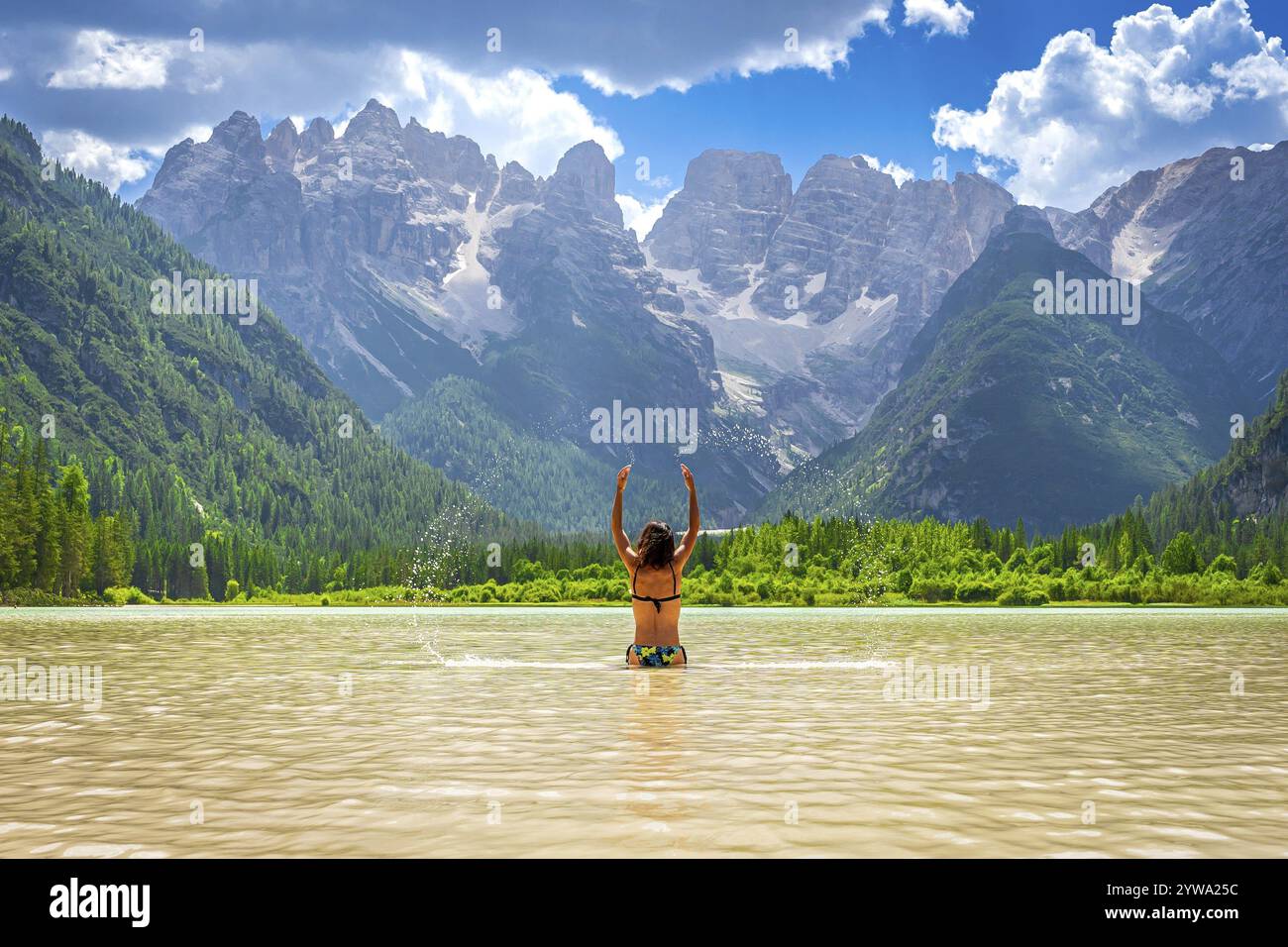 Tourist raising arms in the durrensee lake, enjoying summer holidays in ...