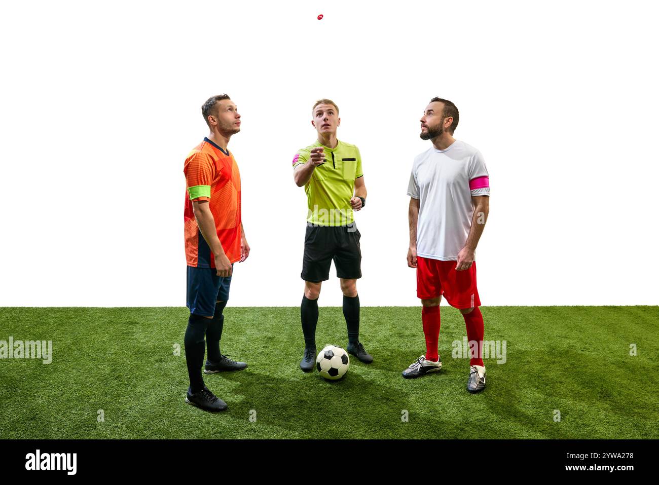 Referee standing between to players from opposite teams and tossing a ...