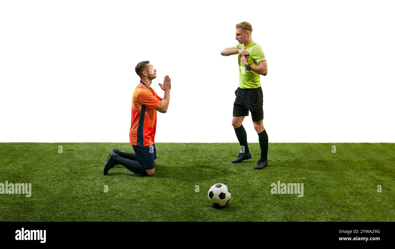 Man, soccer player in orange uniform standing on knees and holding ...