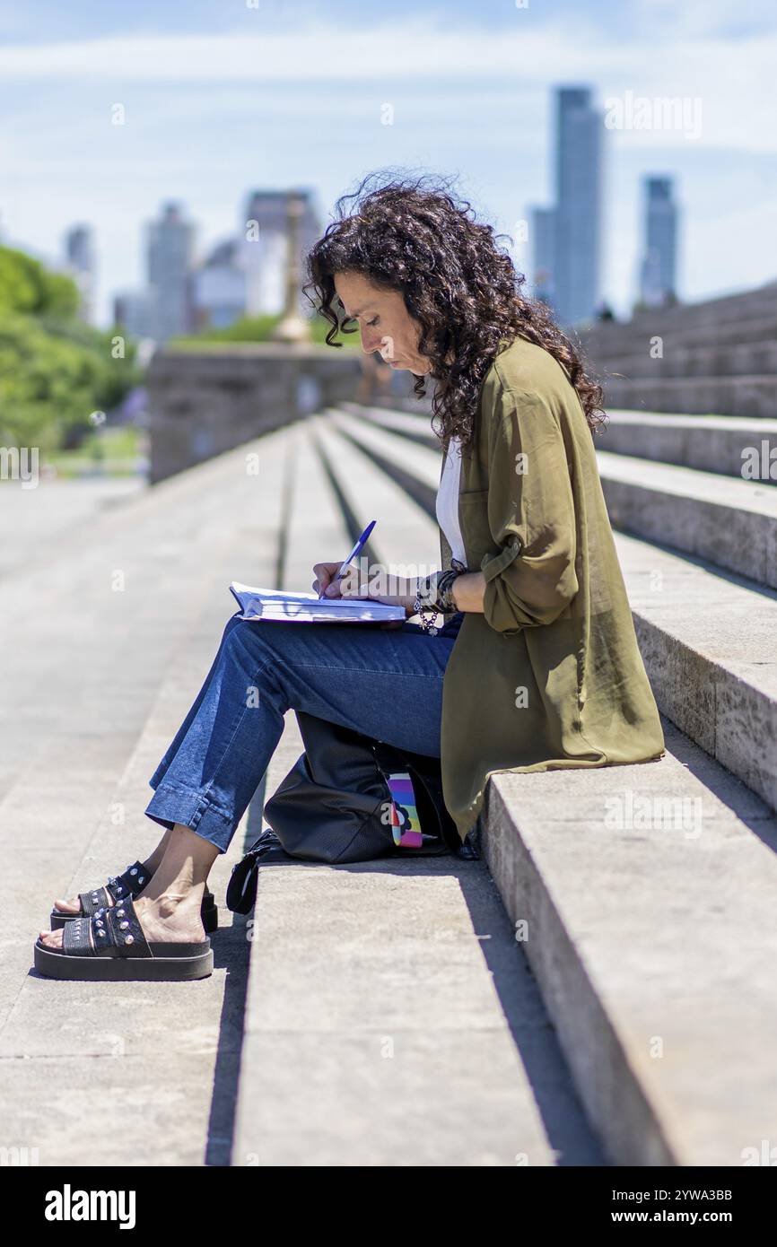 Student drawing in her notebook on university steps Stock Photo - Alamy