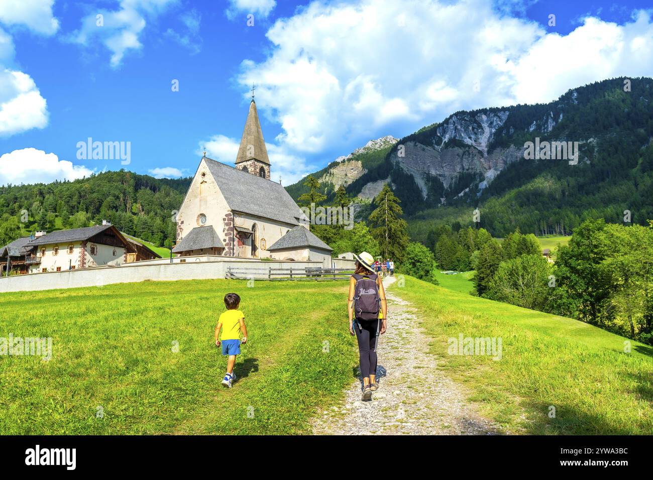 Tourists walking on a path towards the church of st. Magdalena in the ...