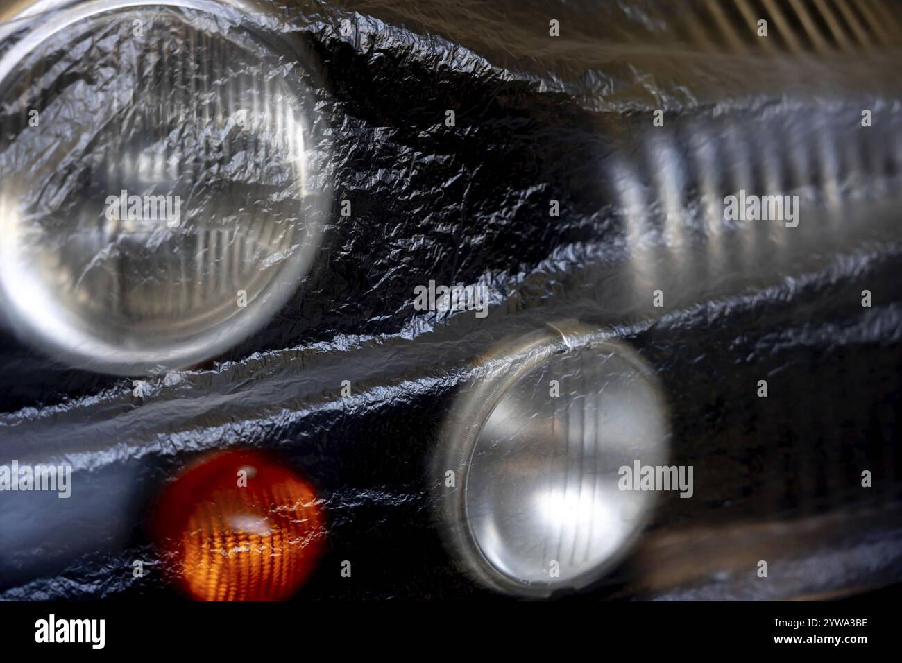 Car Lamps on the Front of a an Old Classic Car Covered with Plastic ...