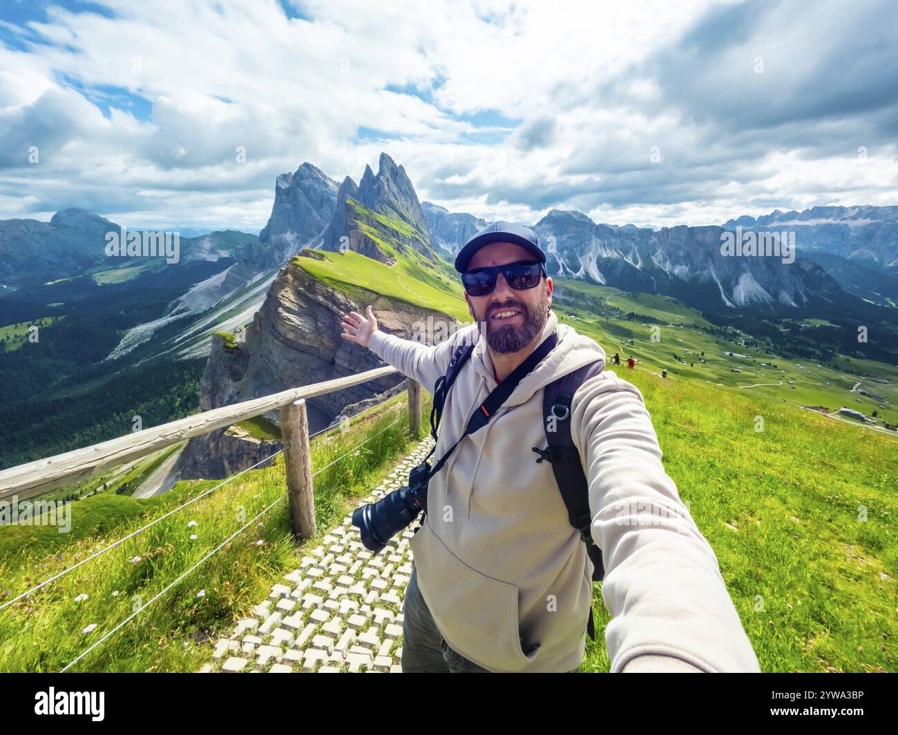 Photographer with backpack and camera taking a selfie portrait with ...