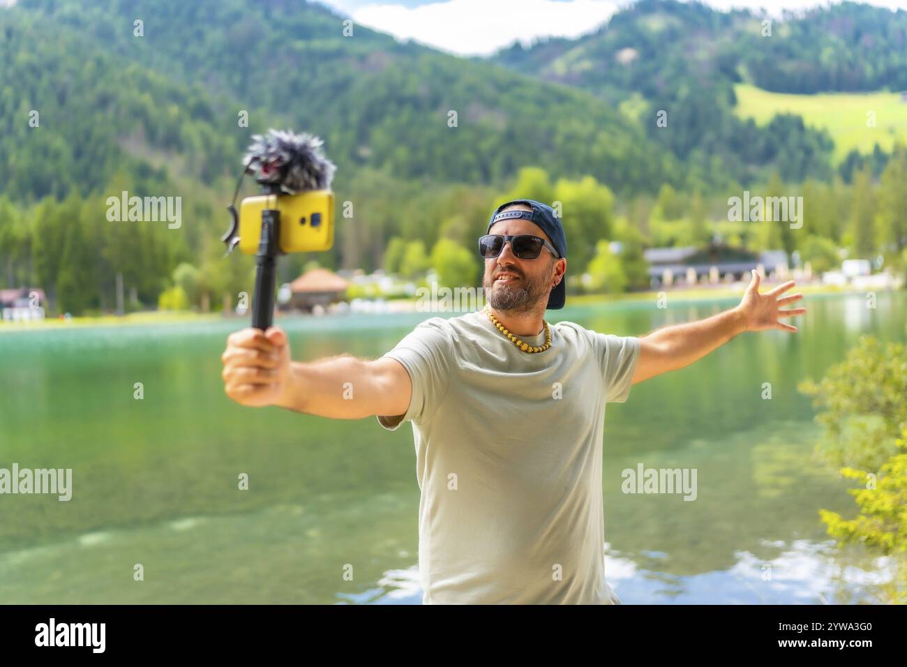 Tourist vlogger recording a video with smartphone and external ...