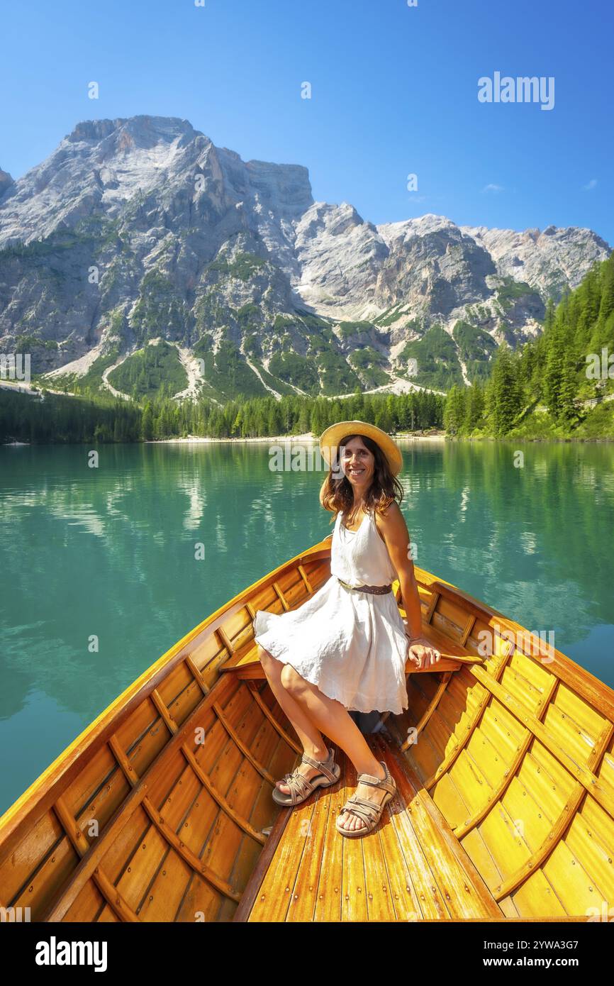 Young woman relaxing on a wooden rowboat, enjoying the breathtaking ...