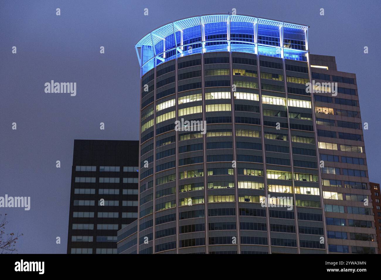 Modern high-rise illuminated at night with blue light, Rotterdam ...