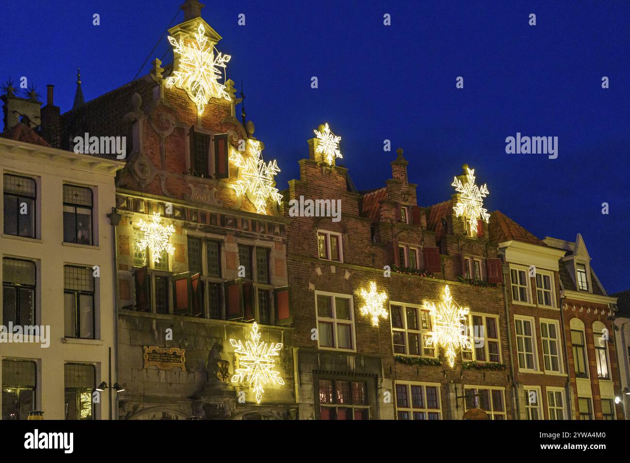 Historic buildings with Christmas lights in the form of snowflakes at ...